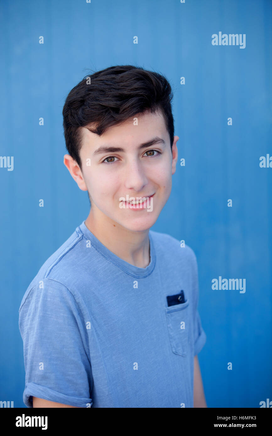 Portrait of a teenager rebellious man with a blue background Stock ...