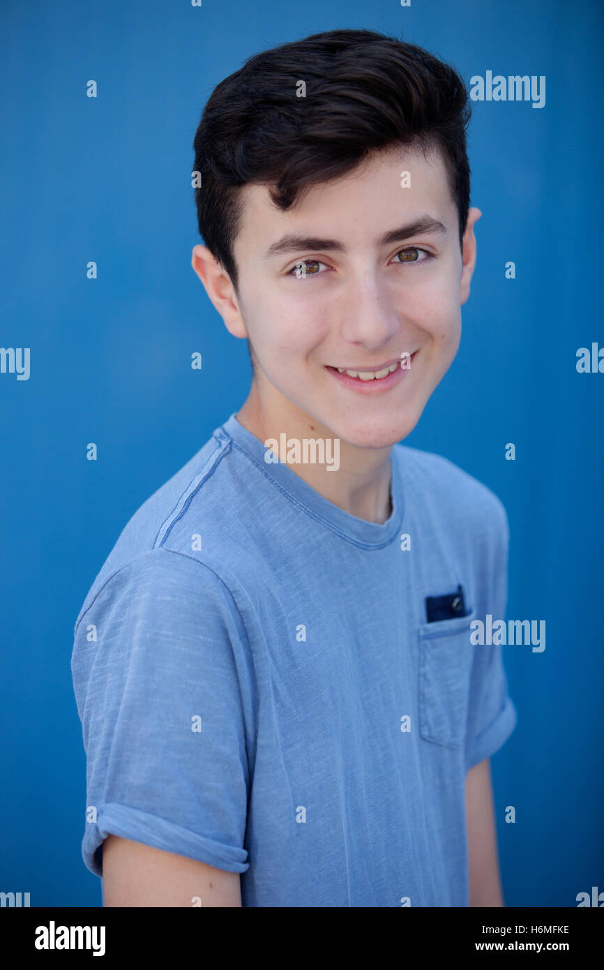 Portrait of a teenager rebellious man with a blue background Stock ...
