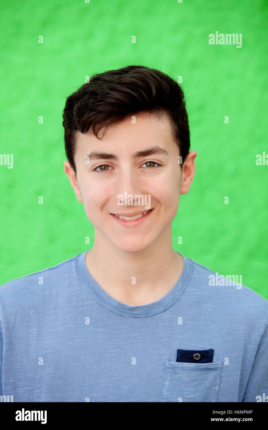 Portrait of a teenager rebellious man with a green background Stock ...