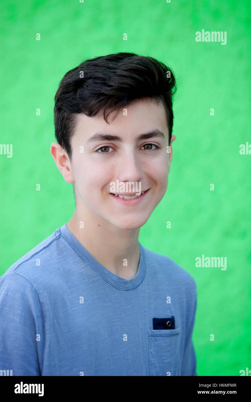 Portrait of a teenager rebellious man with a green background Stock ...