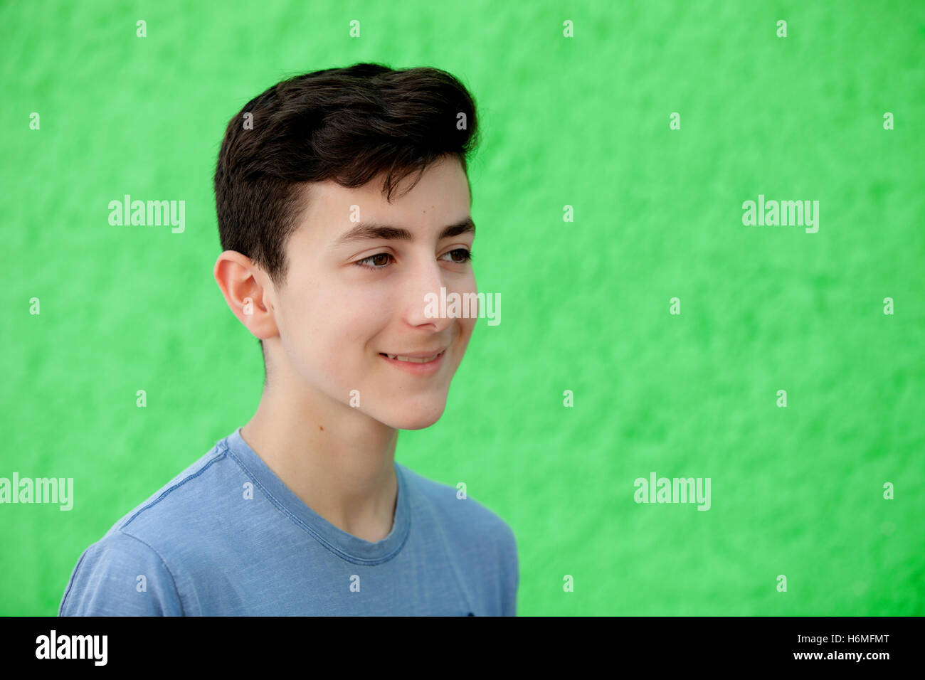 Portrait of a teenager rebellious man with a green background Stock ...