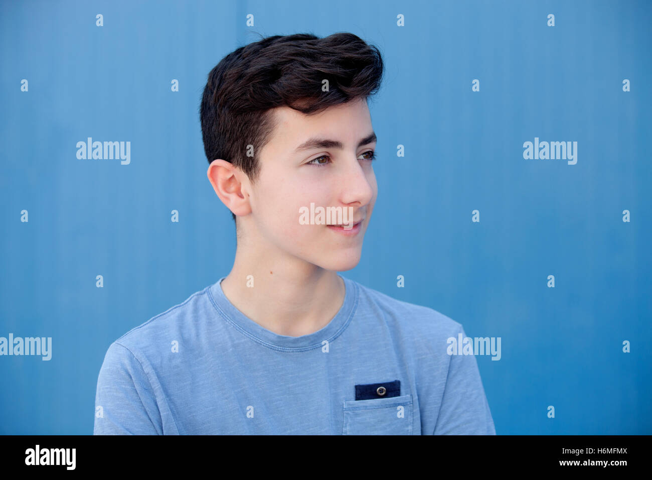 Portrait of a teenager rebellious man with a blue background Stock ...