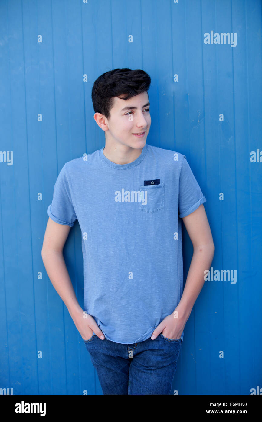 Portrait of a teenager rebellious man with a blue background Stock ...