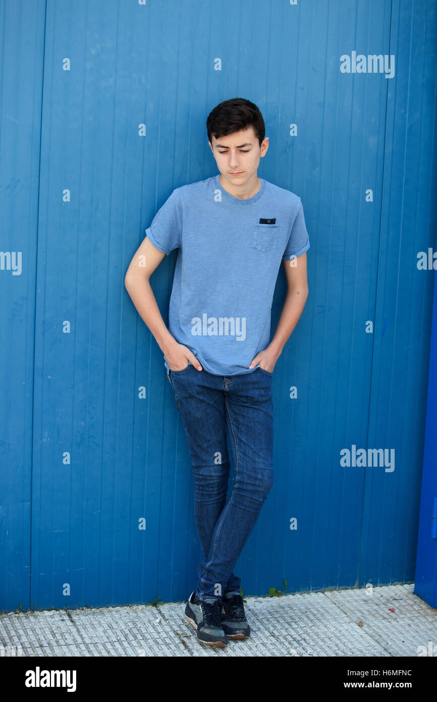 Portrait of a teenager rebellious man with a blue background Stock ...