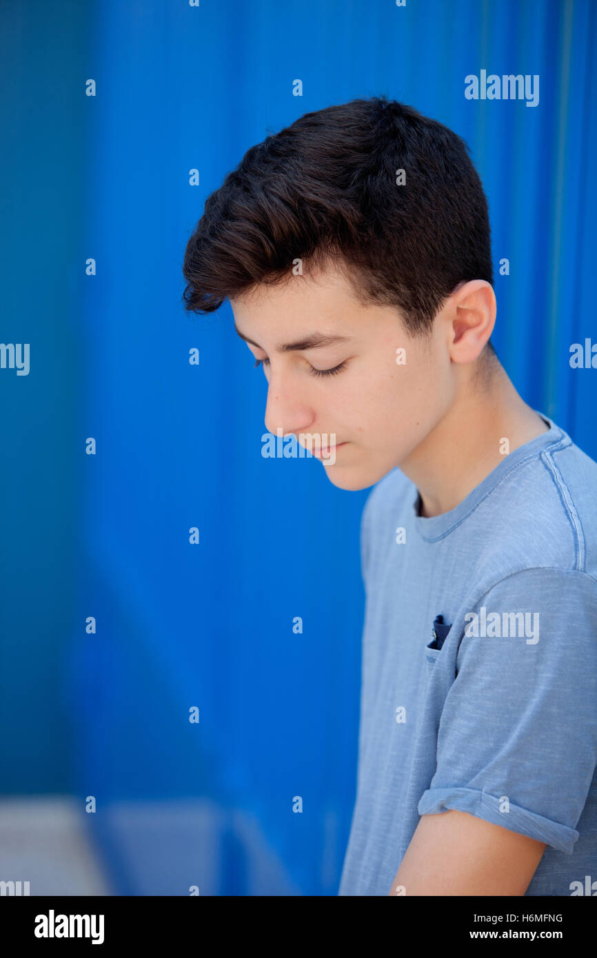Portrait of a teenager rebellious man with a blue background Stock ...