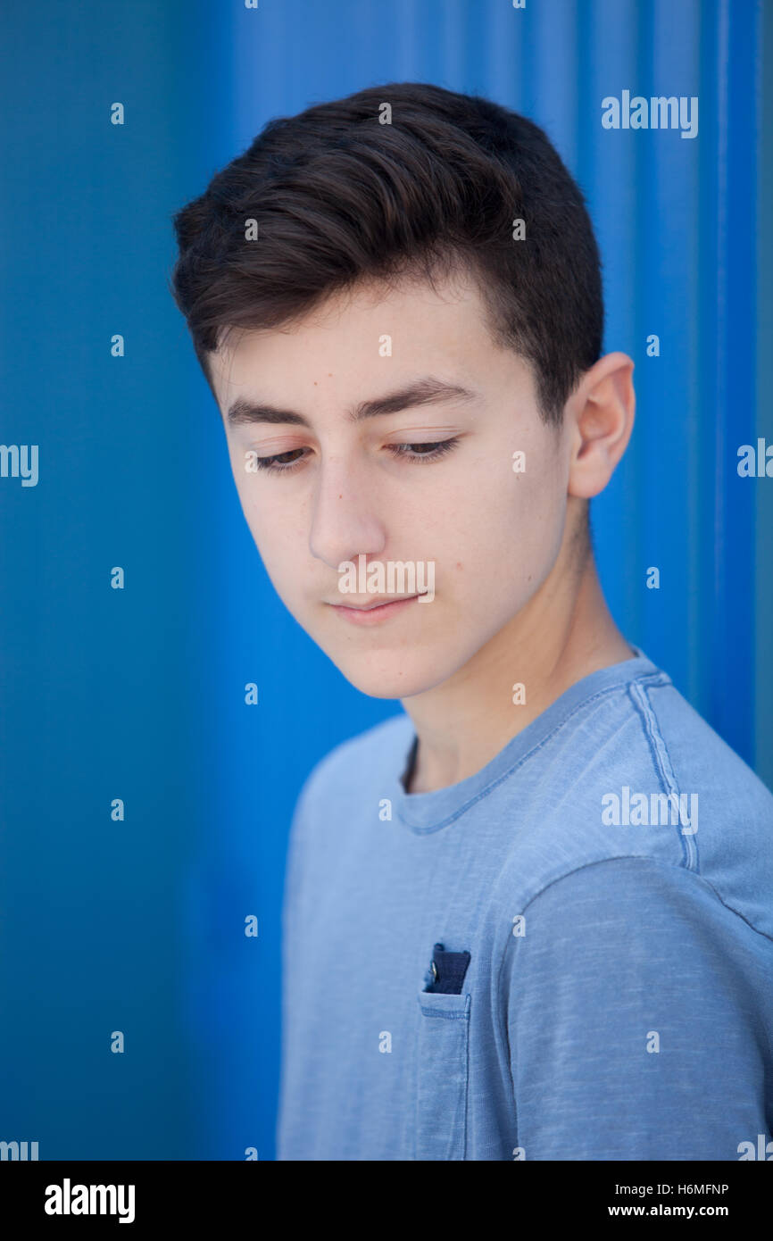 Portrait of a teenager rebellious man with a blue background Stock ...