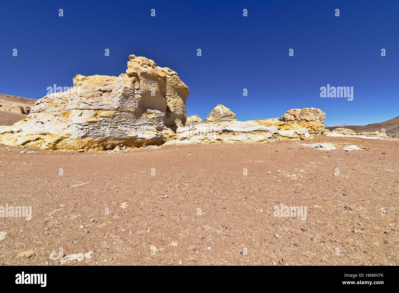 Erosion sculpted yellow rocks in the desert under a beautiful clean sky ...