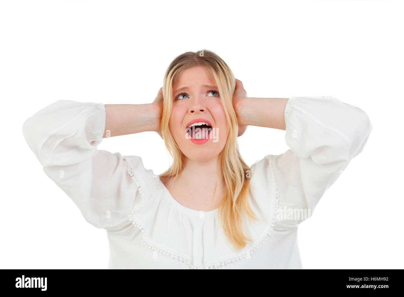 Blonde girl covering her ears isolated on a white background Stock ...