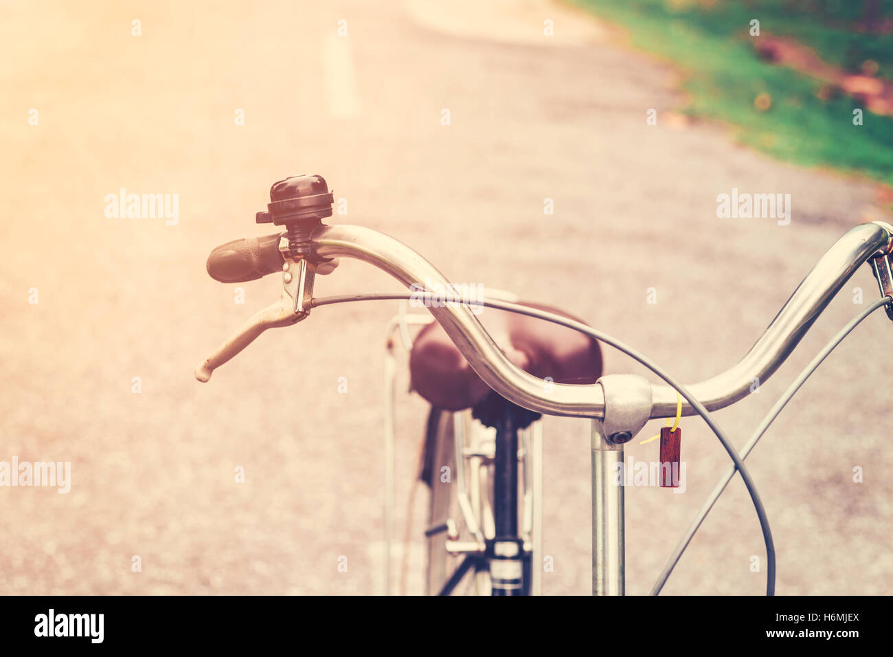 handlebar vintage bicycle on street road with vintage toned Stock Photo ...