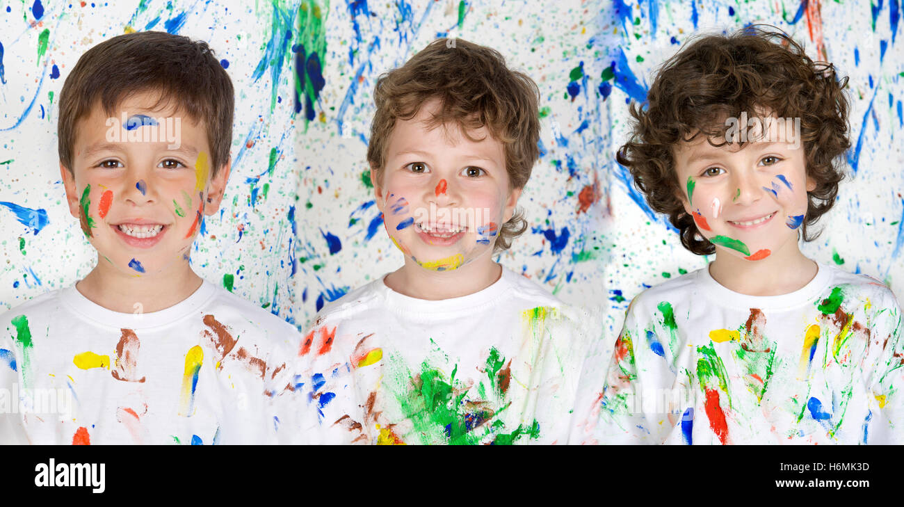 Three happy and painted children stained paint Stock Photo - Alamy
