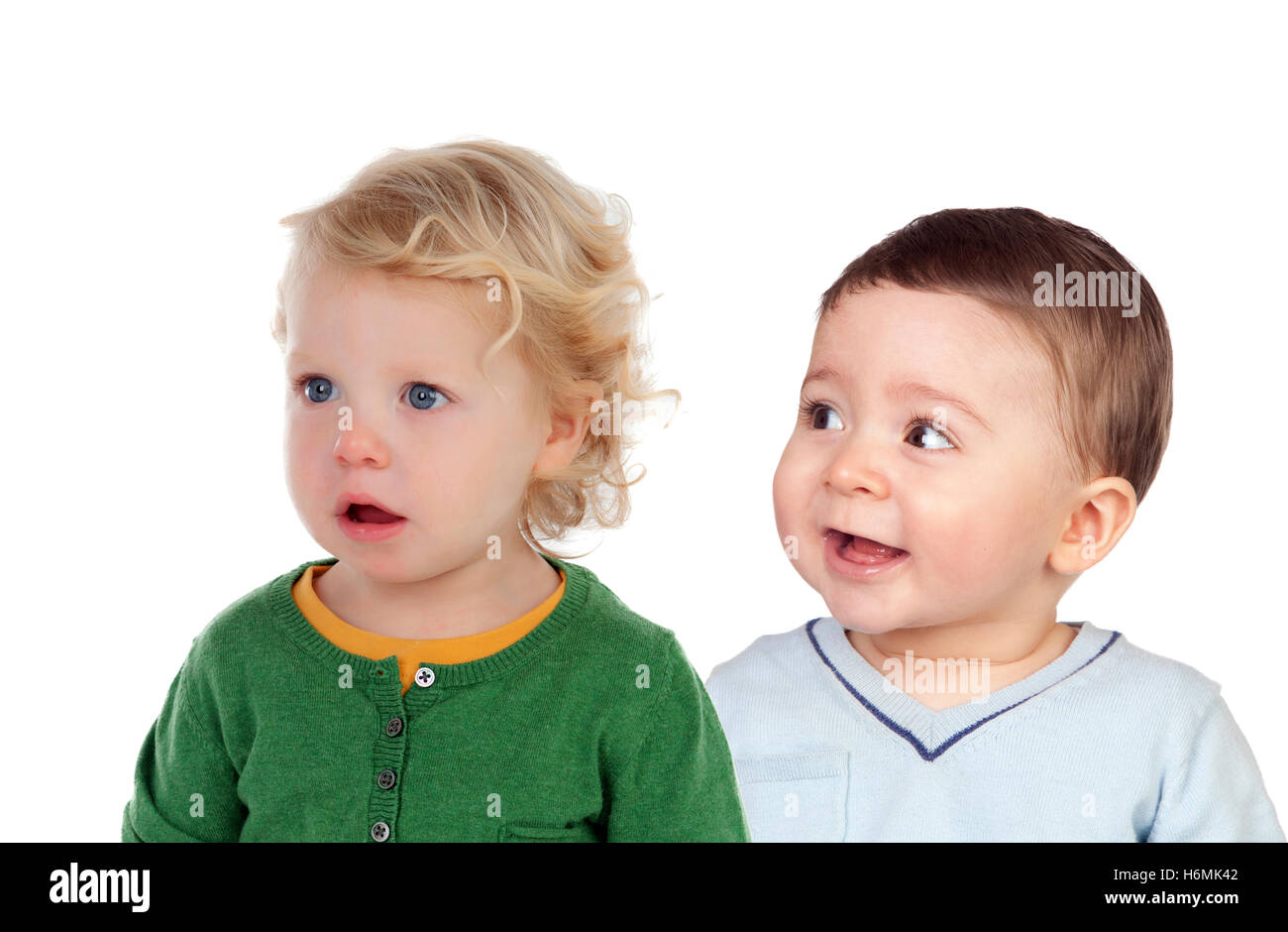 Two beautiful children looking at side isolated on a white background ...