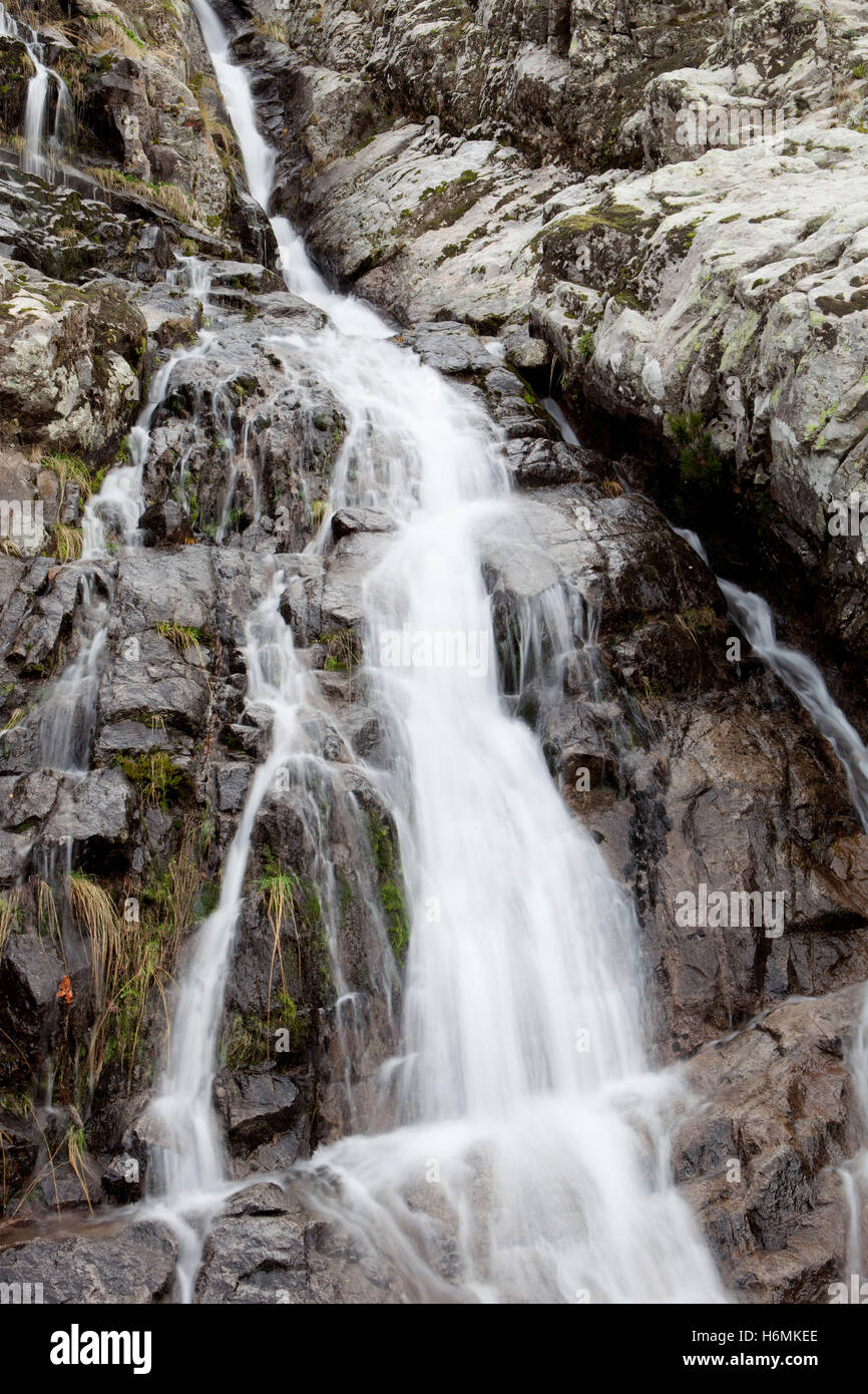 Beautiful waterfall falling on a stone wall Stock Photo - Alamy