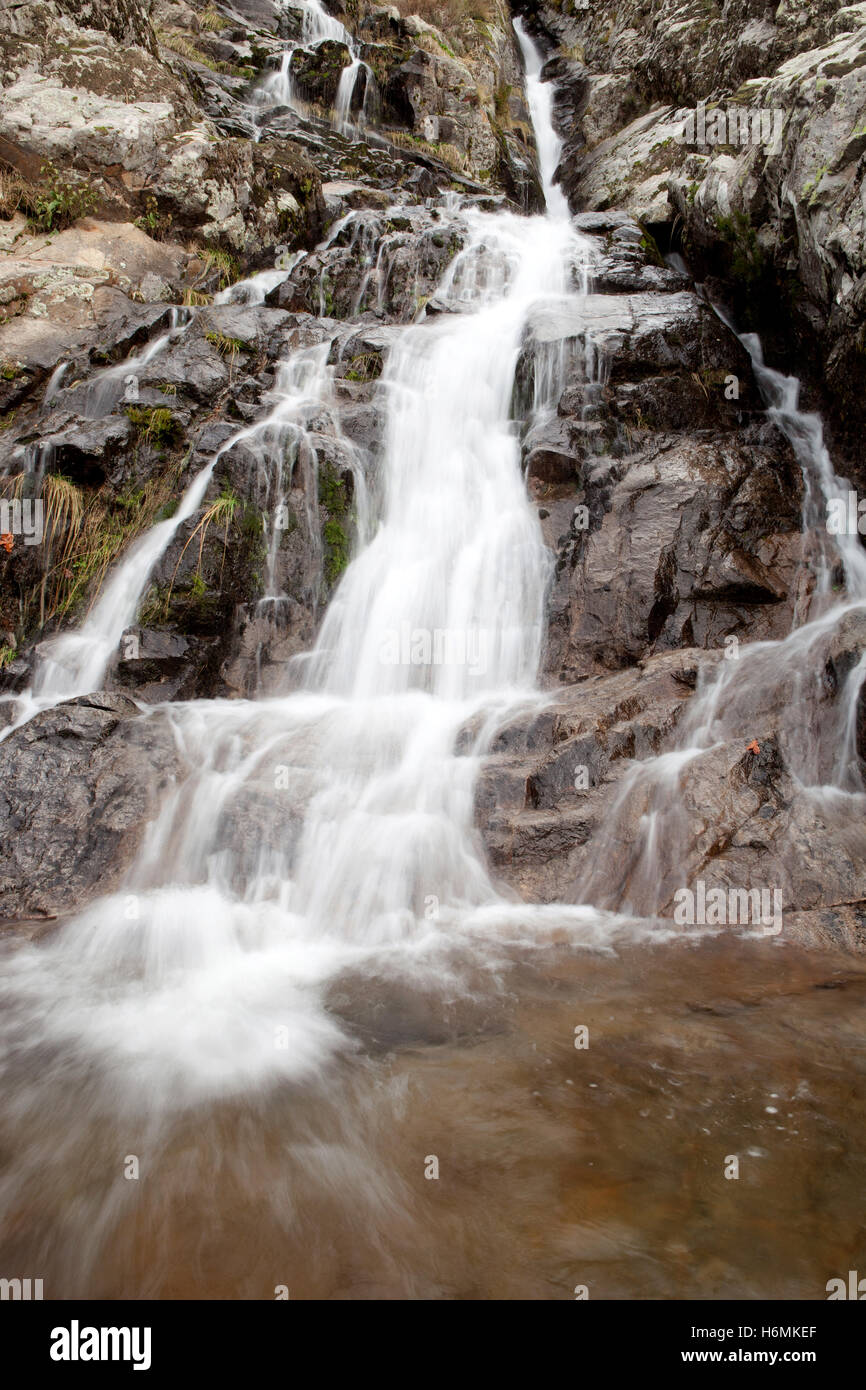 Beautiful waterfall falling on a stone wall Stock Photo - Alamy