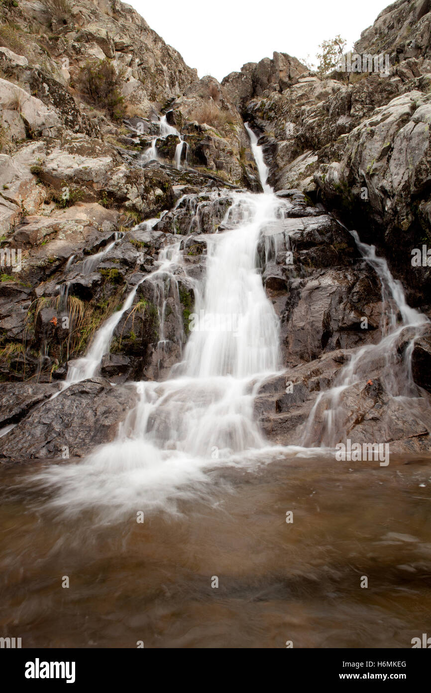Beautiful waterfall falling on a stone wall Stock Photo - Alamy