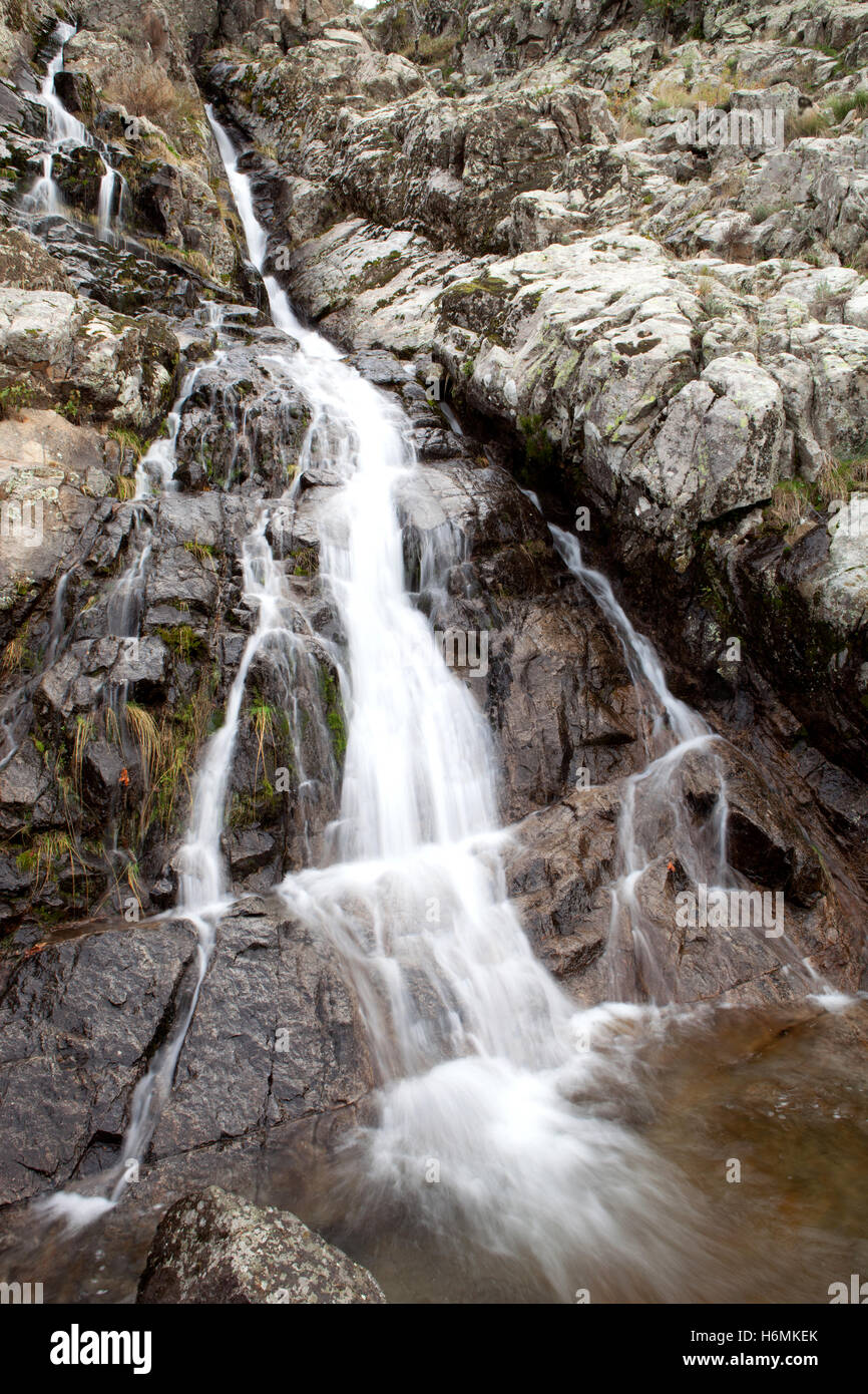 Beautiful waterfall falling on a stone wall Stock Photo - Alamy