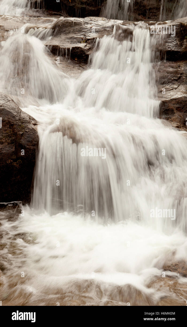 Beautiful waterfall falling on a stone wall Stock Photo - Alamy