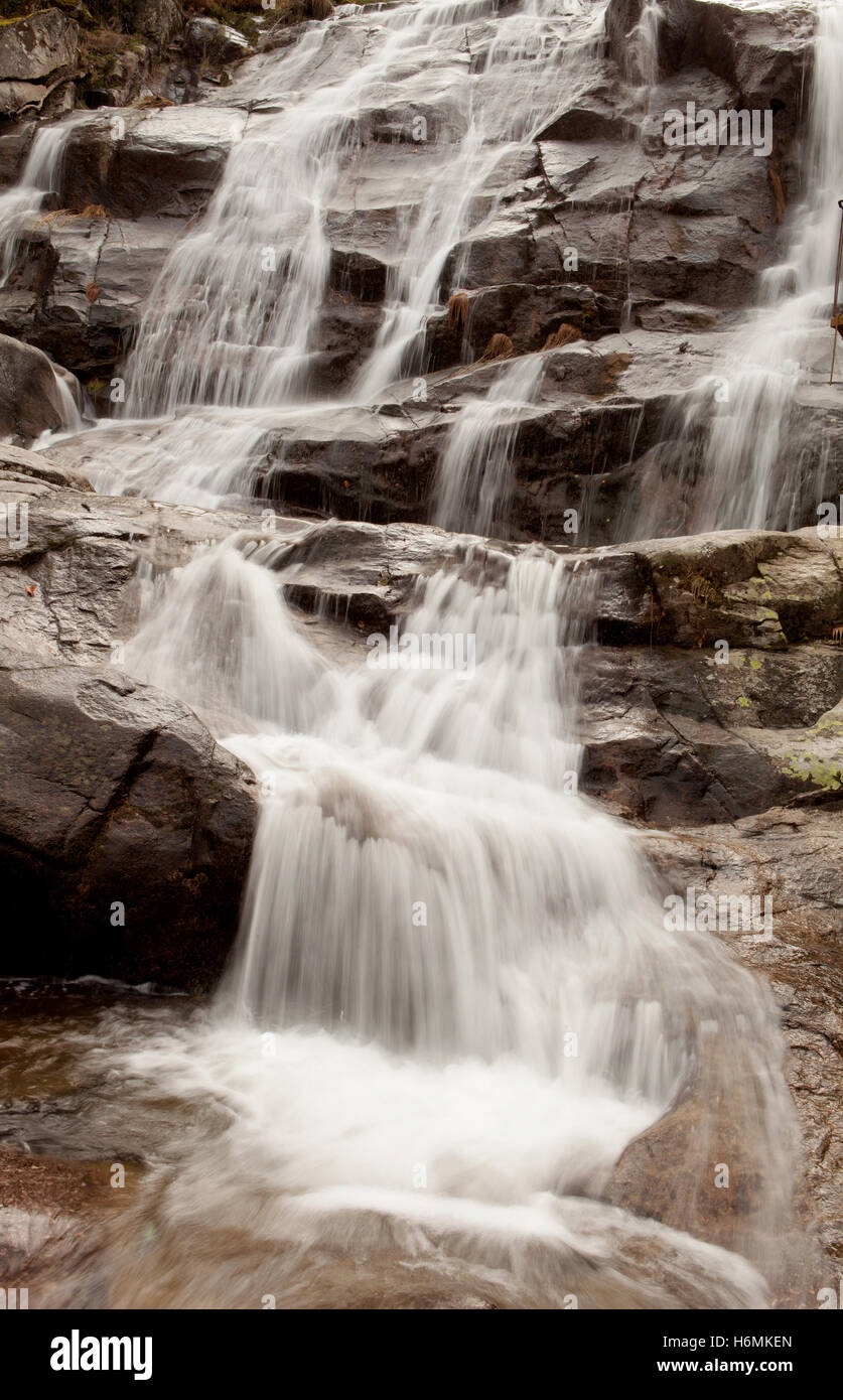 Beautiful waterfall falling on a stone wall Stock Photo - Alamy