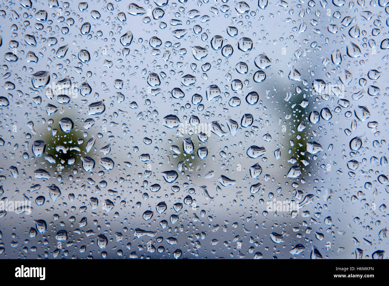 Wet glass with drops of rain fall on the street Stock Photo - Alamy