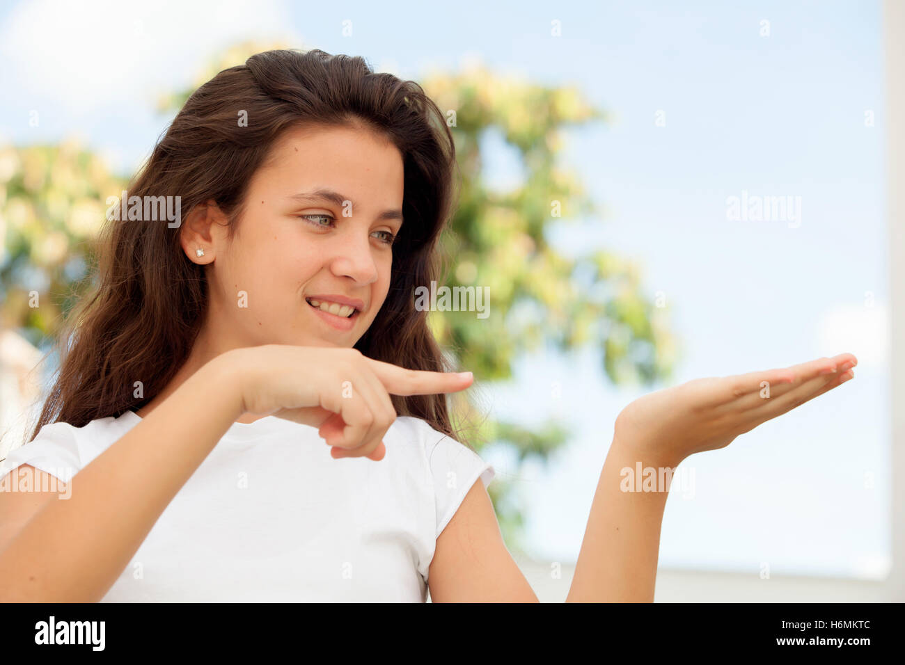 Pretty teenager girl pointing her hand outdoor Stock Photo - Alamy
