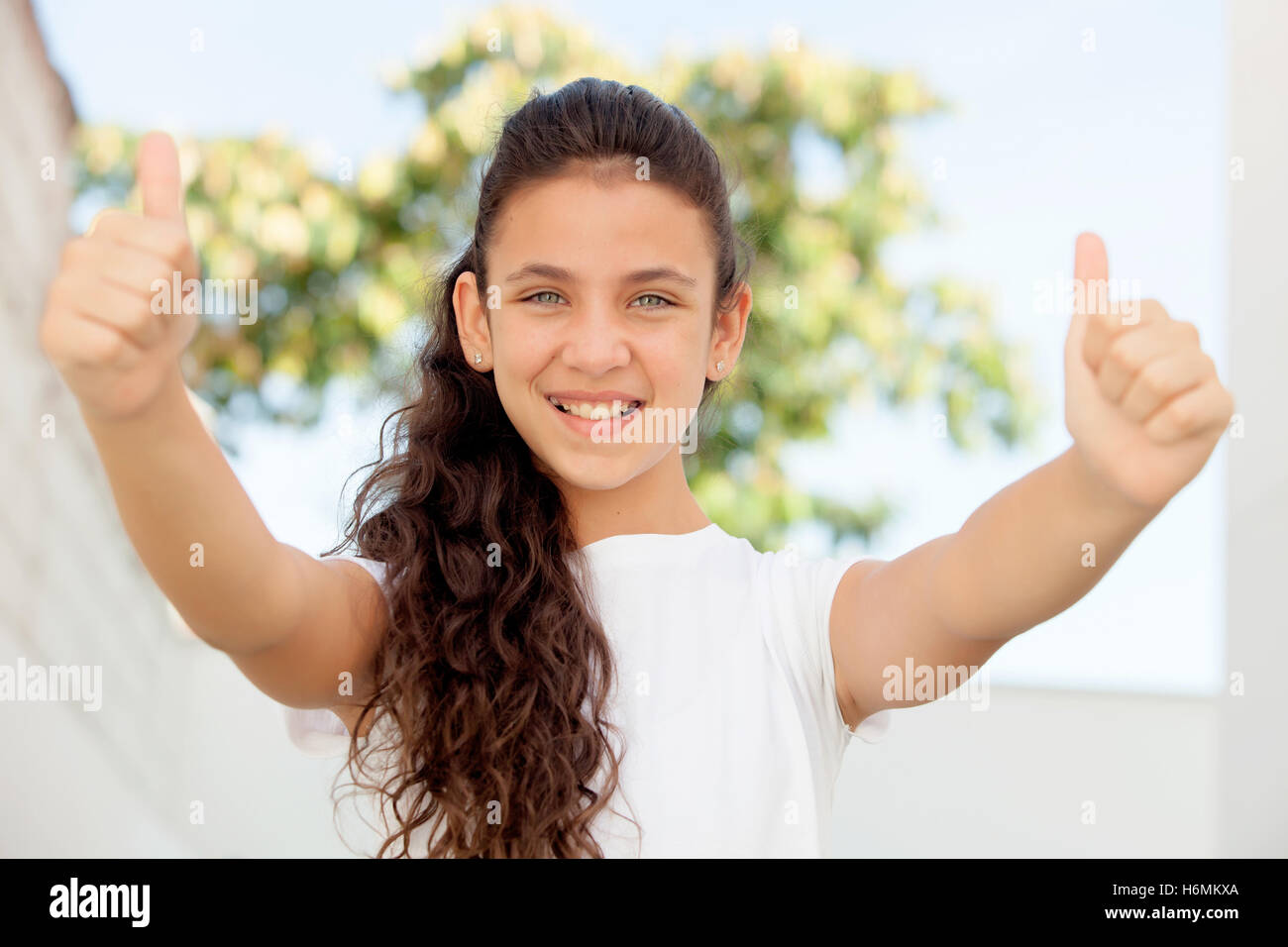 Smiling teenager girl saying ok outside Stock Photo - Alamy