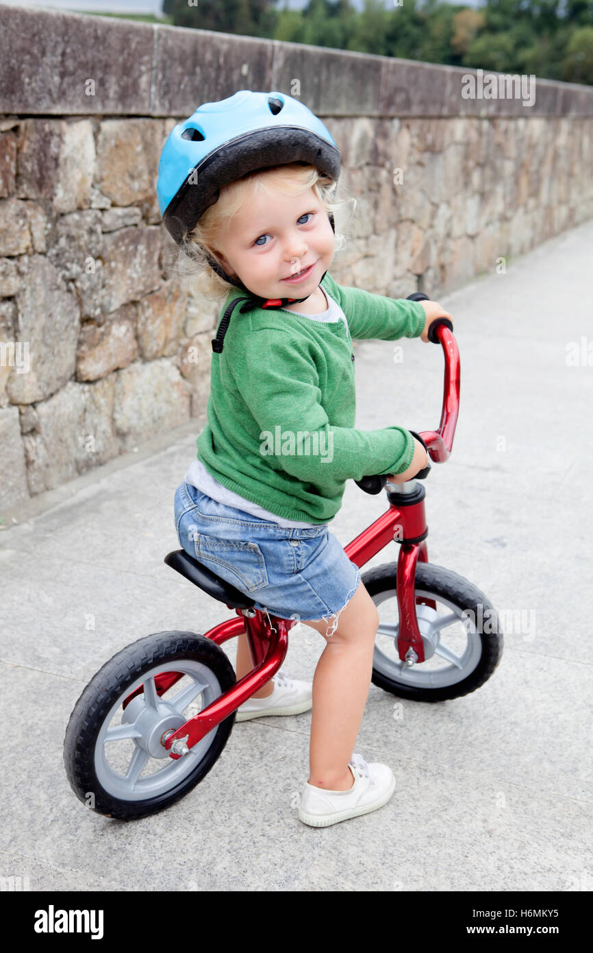 Little kid riding his bike down the street Stock Photo - Alamy