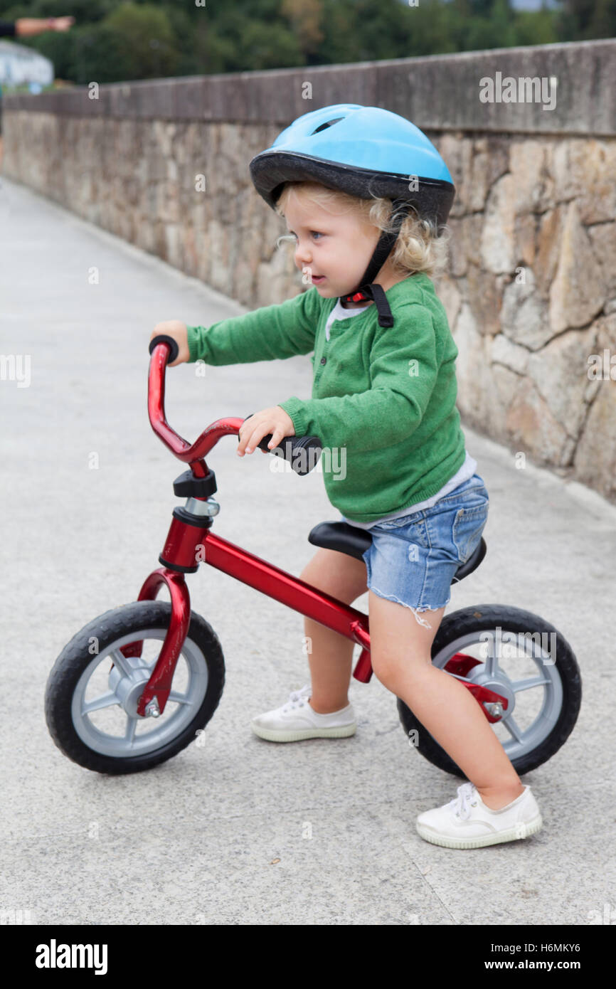 Little kid riding his bike down the street Stock Photo - Alamy