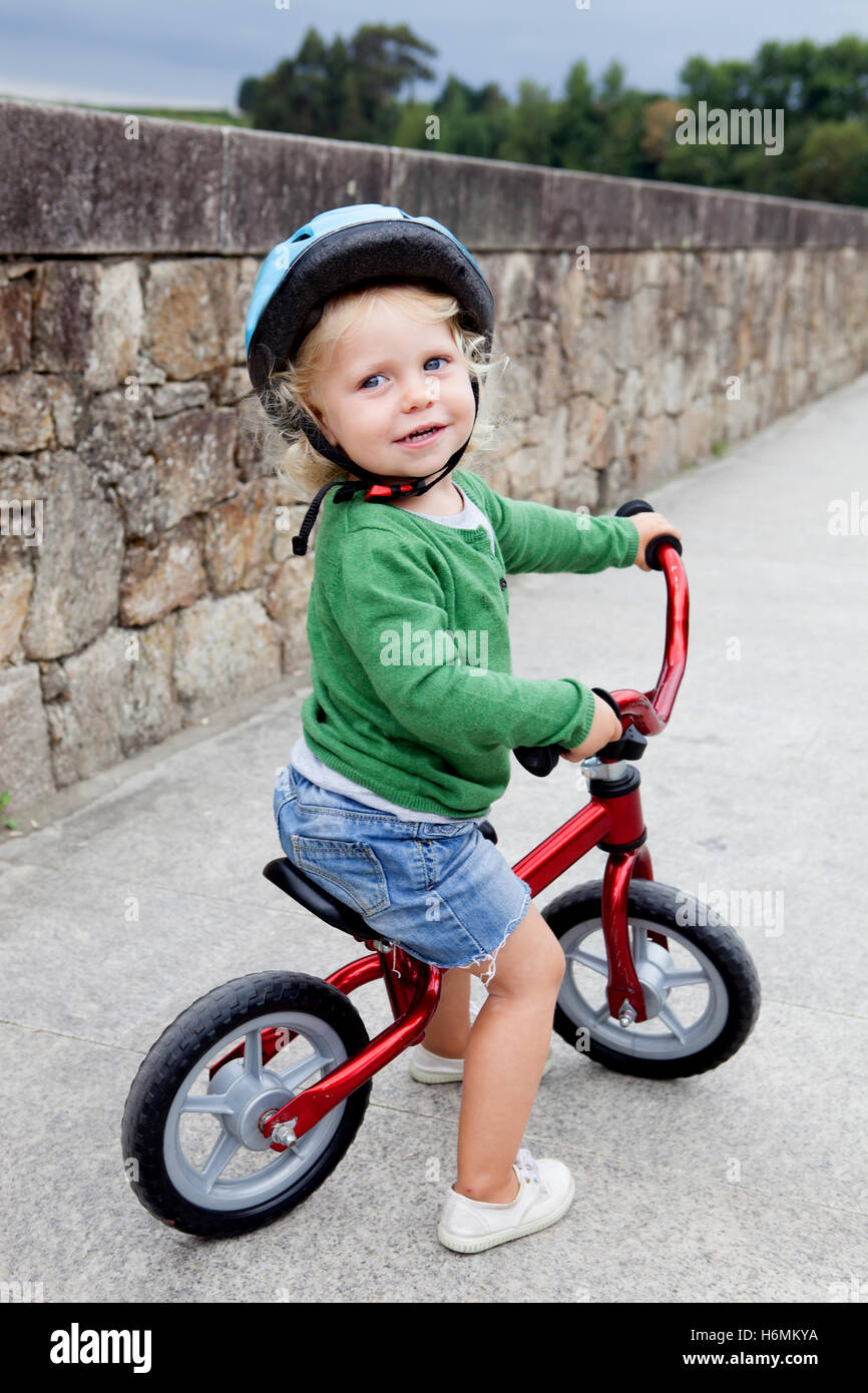 Little kid riding his bike down the street Stock Photo - Alamy