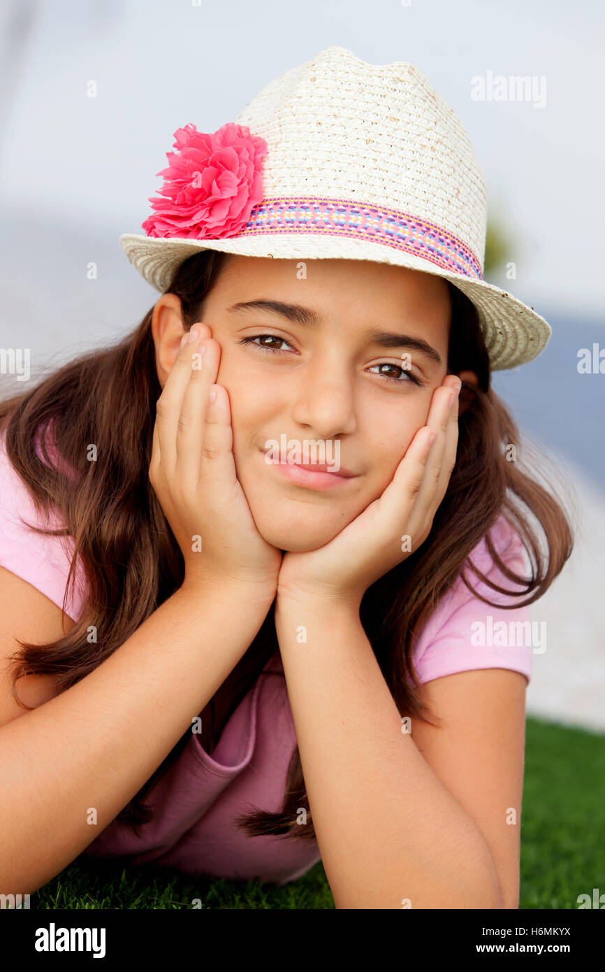 Nice child girl ten year old with a hat on the street Stock Photo - Alamy