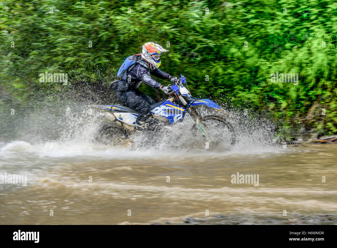 motorcycle Enduro river in a shallow place of the spray Stock Photo - Alamy
