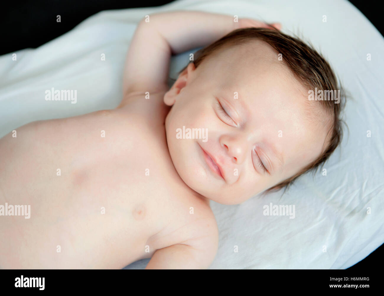 Tender baby smiling while nap in the crib Stock Photo - Alamy