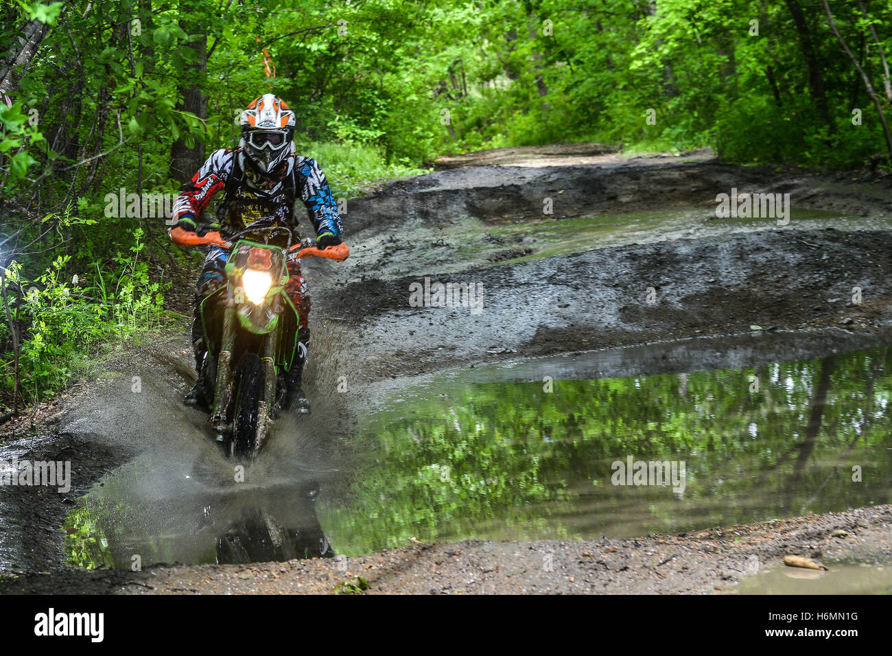 enduro moto in the mud with a big splash Stock Photo - Alamy