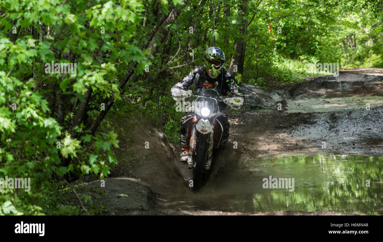 enduro moto in the mud with a big splash Stock Photo - Alamy