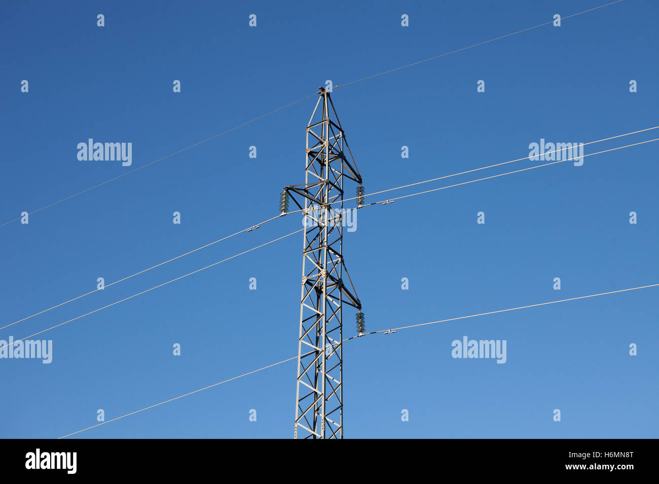 Metal pylon with a blue sky background Stock Photo - Alamy