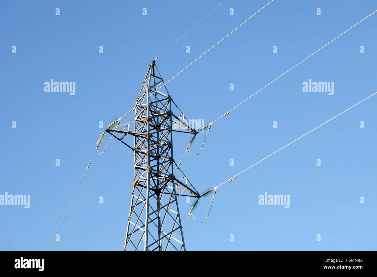 Metal pylon with a blue sky background Stock Photo - Alamy