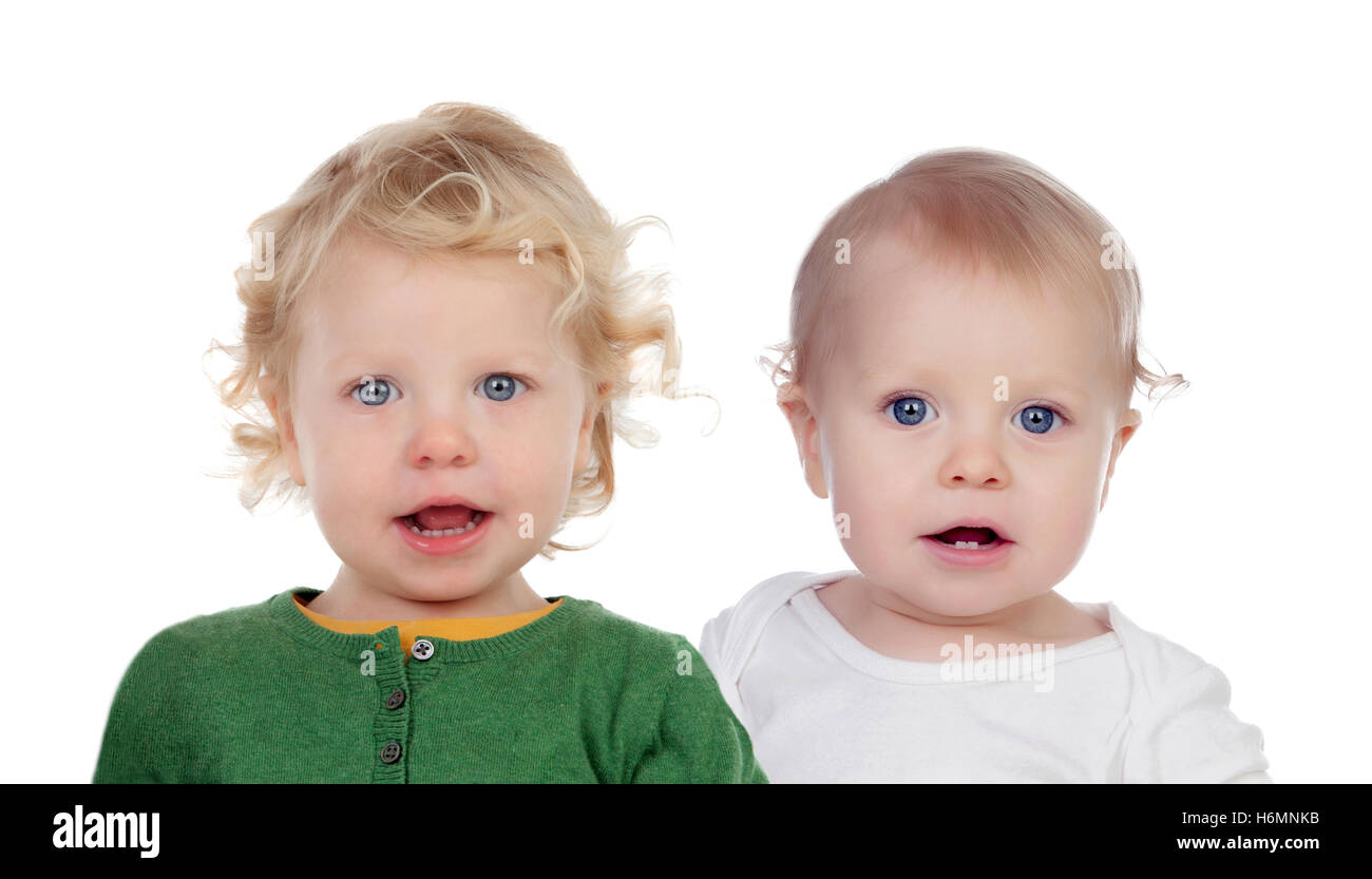 Couple of twins sitting on the floor isolated on a white background ...