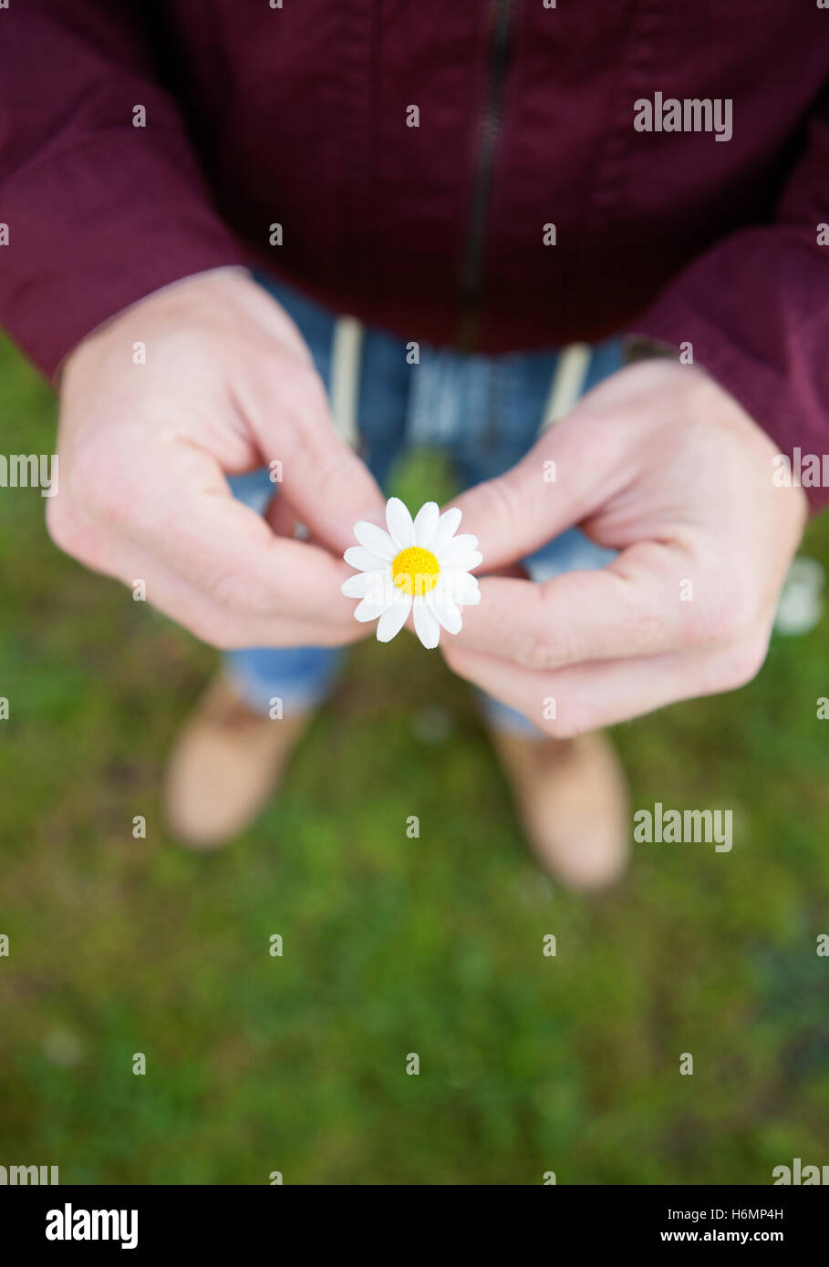 Child offering flower hi-res stock photography and images - Alamy