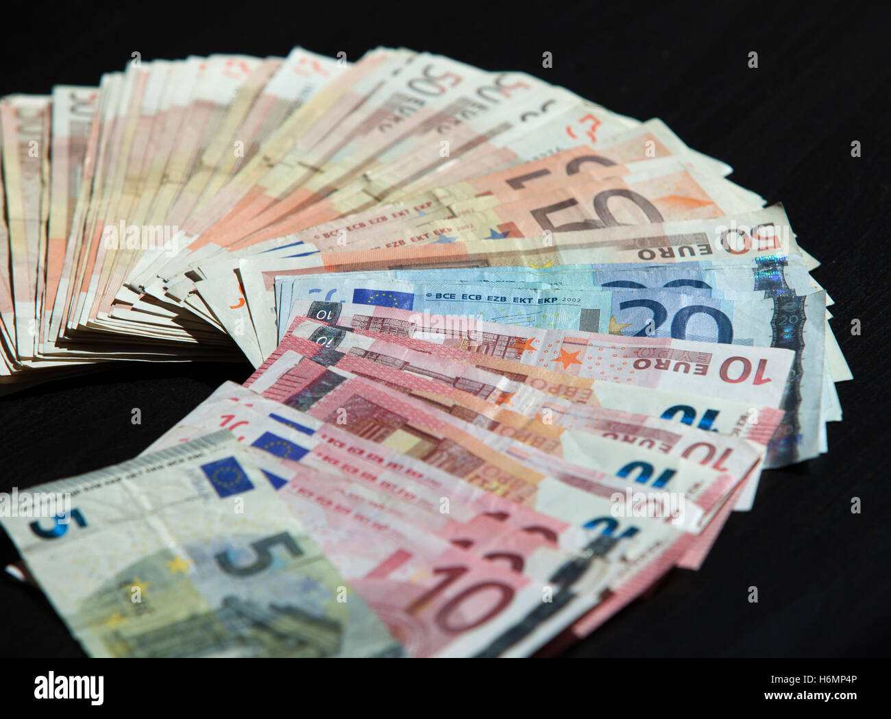 Many cash on black background. Used bank notes Stock Photo - Alamy
