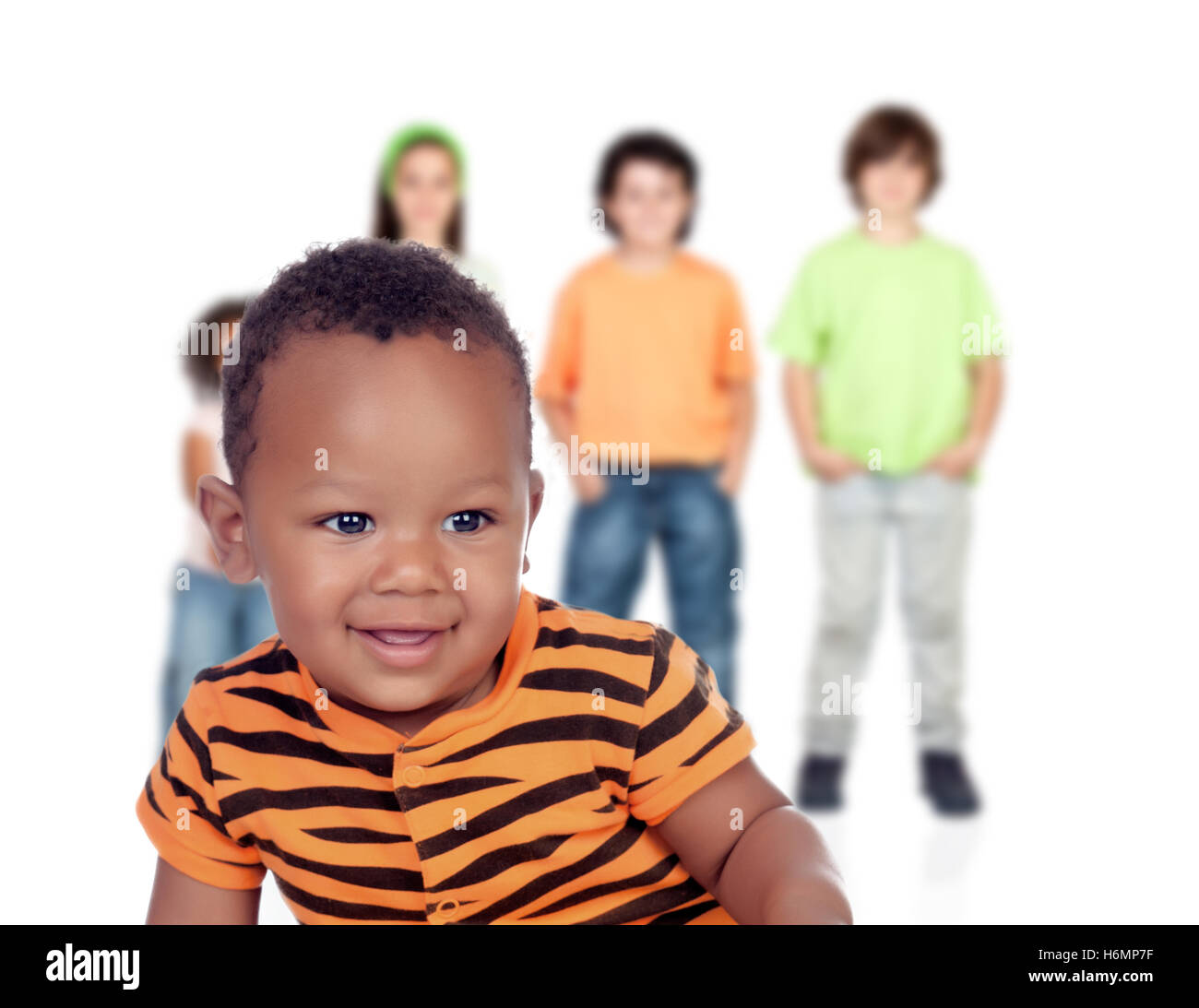 Funny afroamerican baby with other children unfocused of background ...