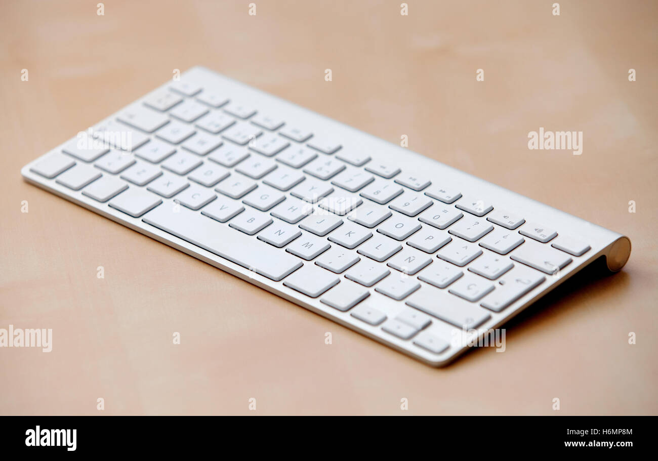 Silver computer keyboard over wooden surface Stock Photo - Alamy