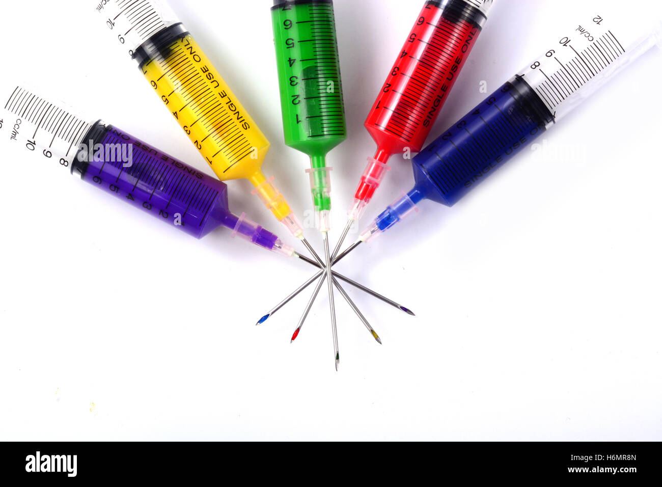 Syringe filled with colors Stock Photo - Alamy