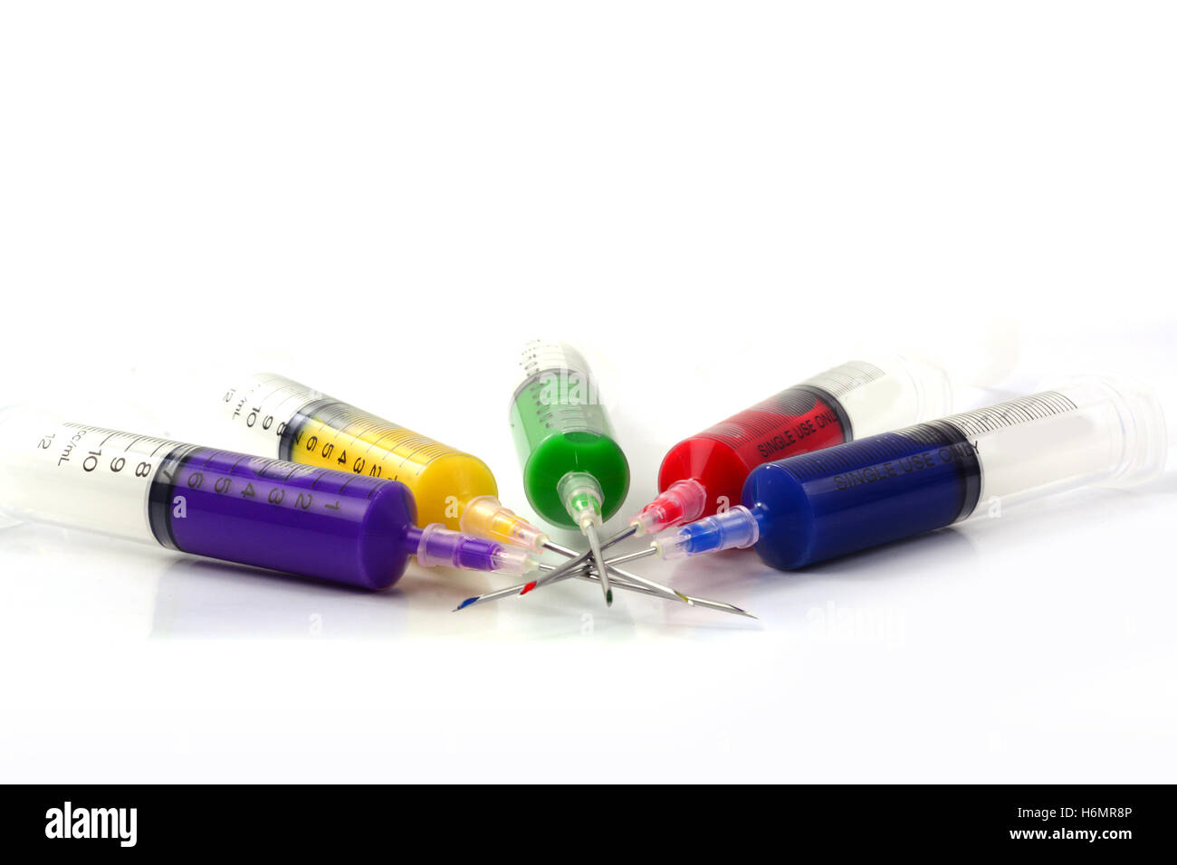 Syringe filled with colors Stock Photo - Alamy