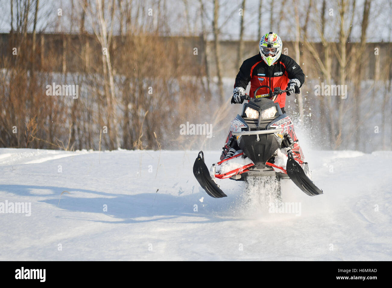 man and fast action snowmobile jumping Stock Photo - Alamy