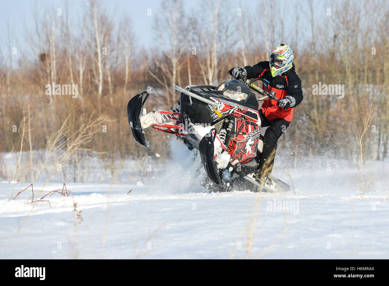 man and fast action snowmobile jumping Stock Photo - Alamy