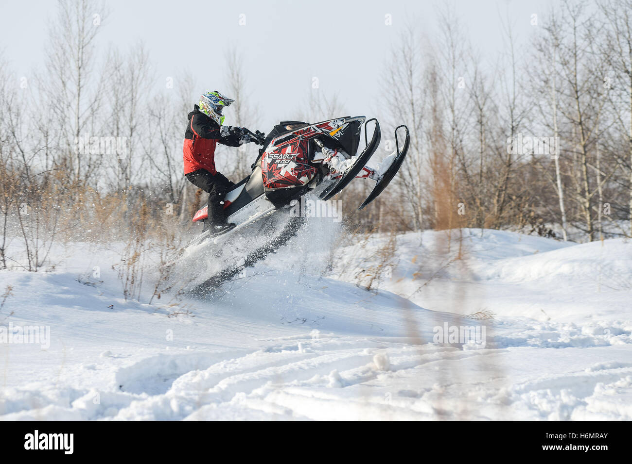 man and fast action snowmobile jumping Stock Photo - Alamy