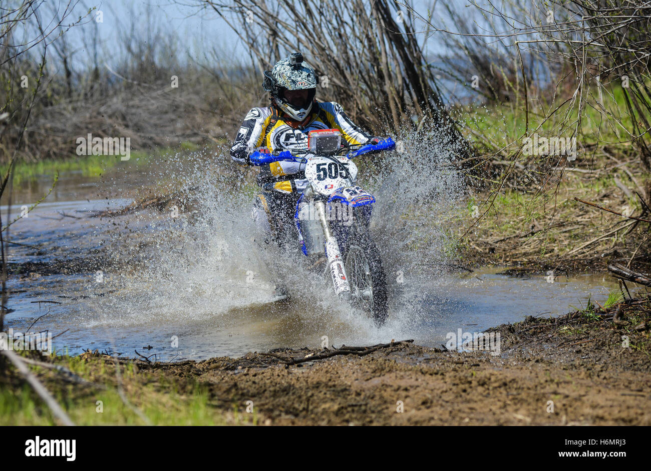 Enduro motorcycle rides through the mud with a big splash Stock Photo ...