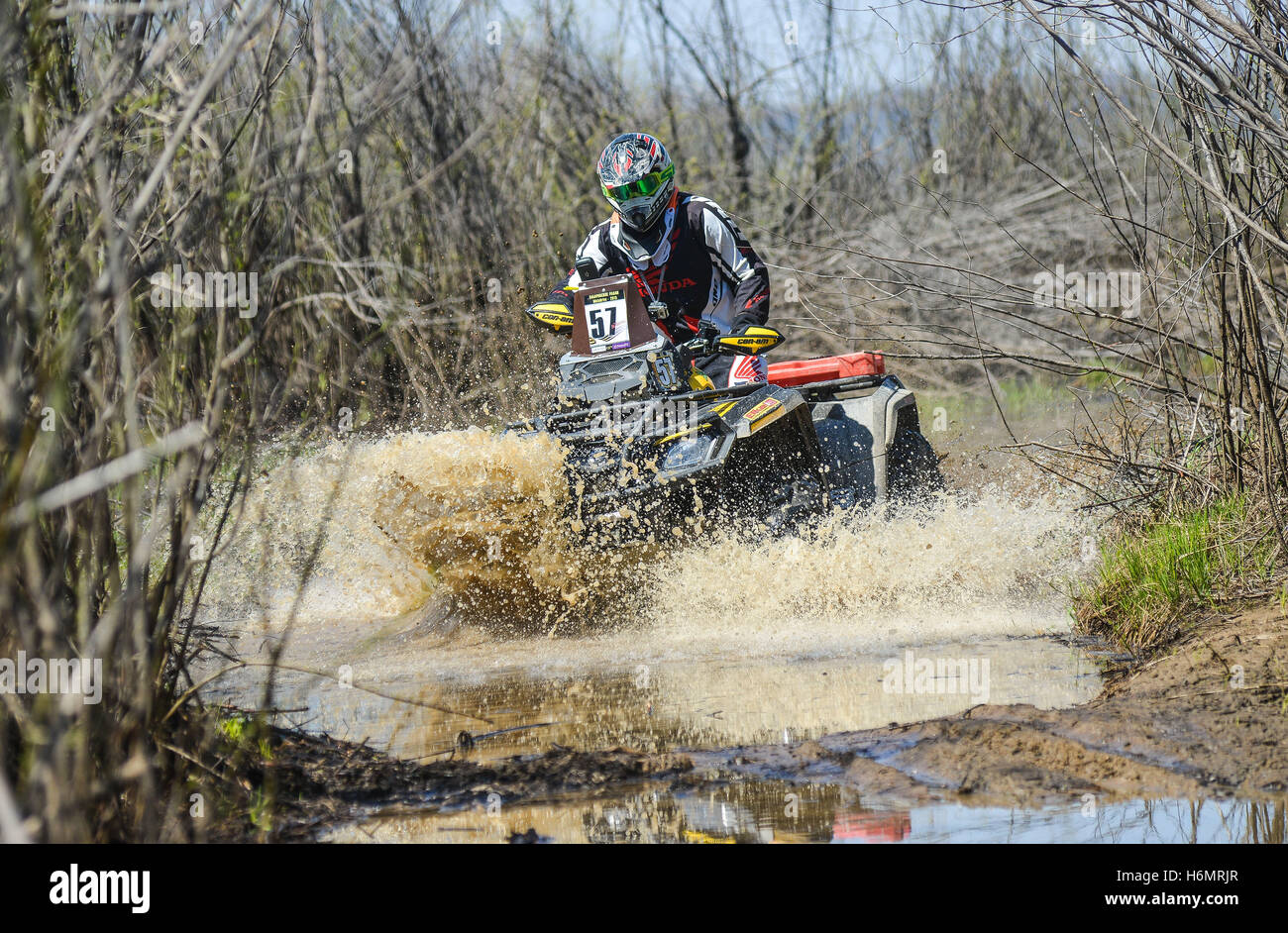 ATV rides through the mud with a big splash Stock Photo - Alamy