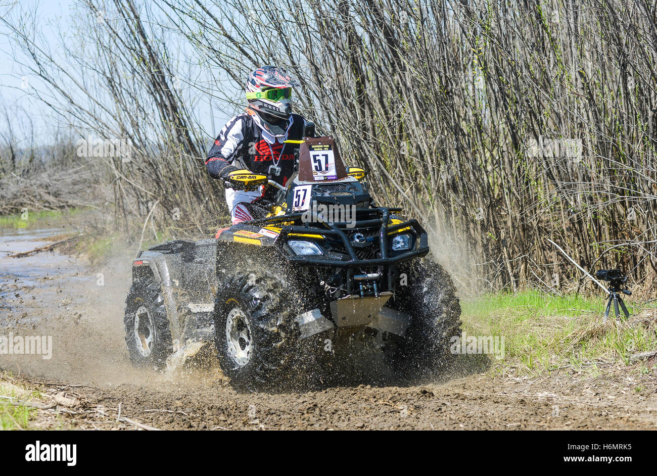 ATV rides through the mud with a big splash Stock Photo - Alamy