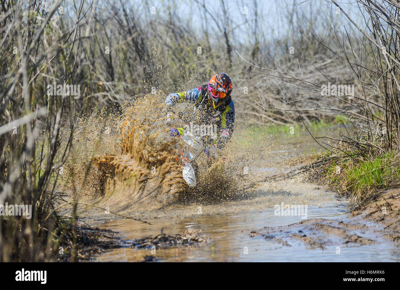 Enduro motorcycle rides through the mud with a big splash Stock Photo ...