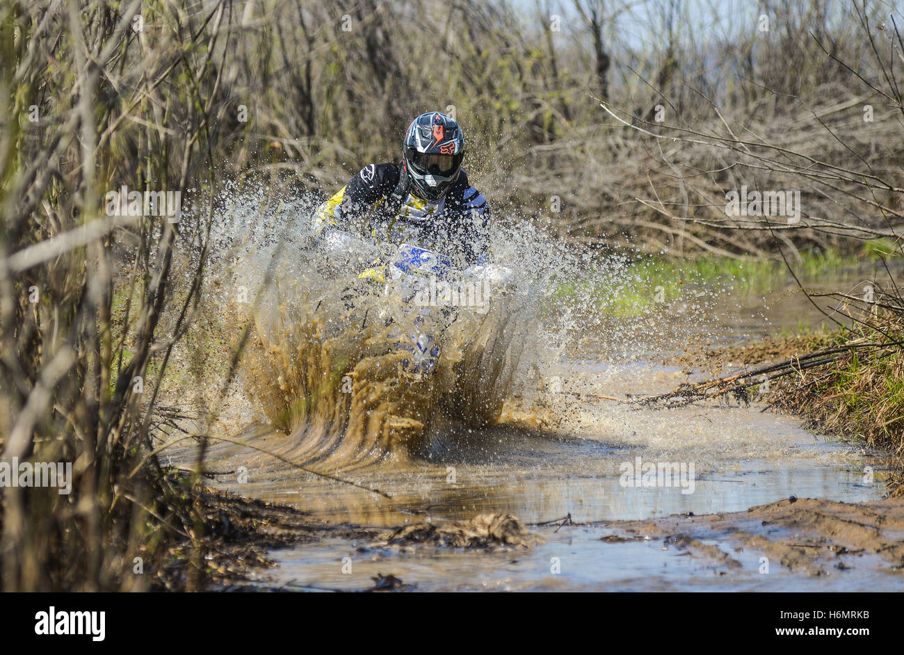 Enduro motorcycle rides through the mud with a big splash Stock Photo ...