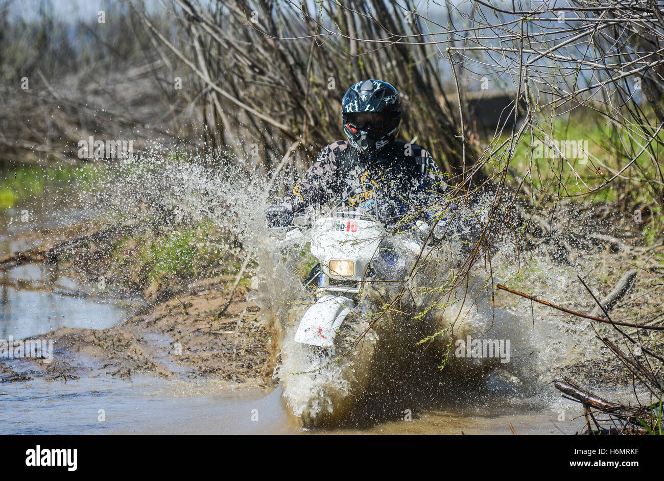 Enduro motorcycle rides through the mud with a big splash Stock Photo ...